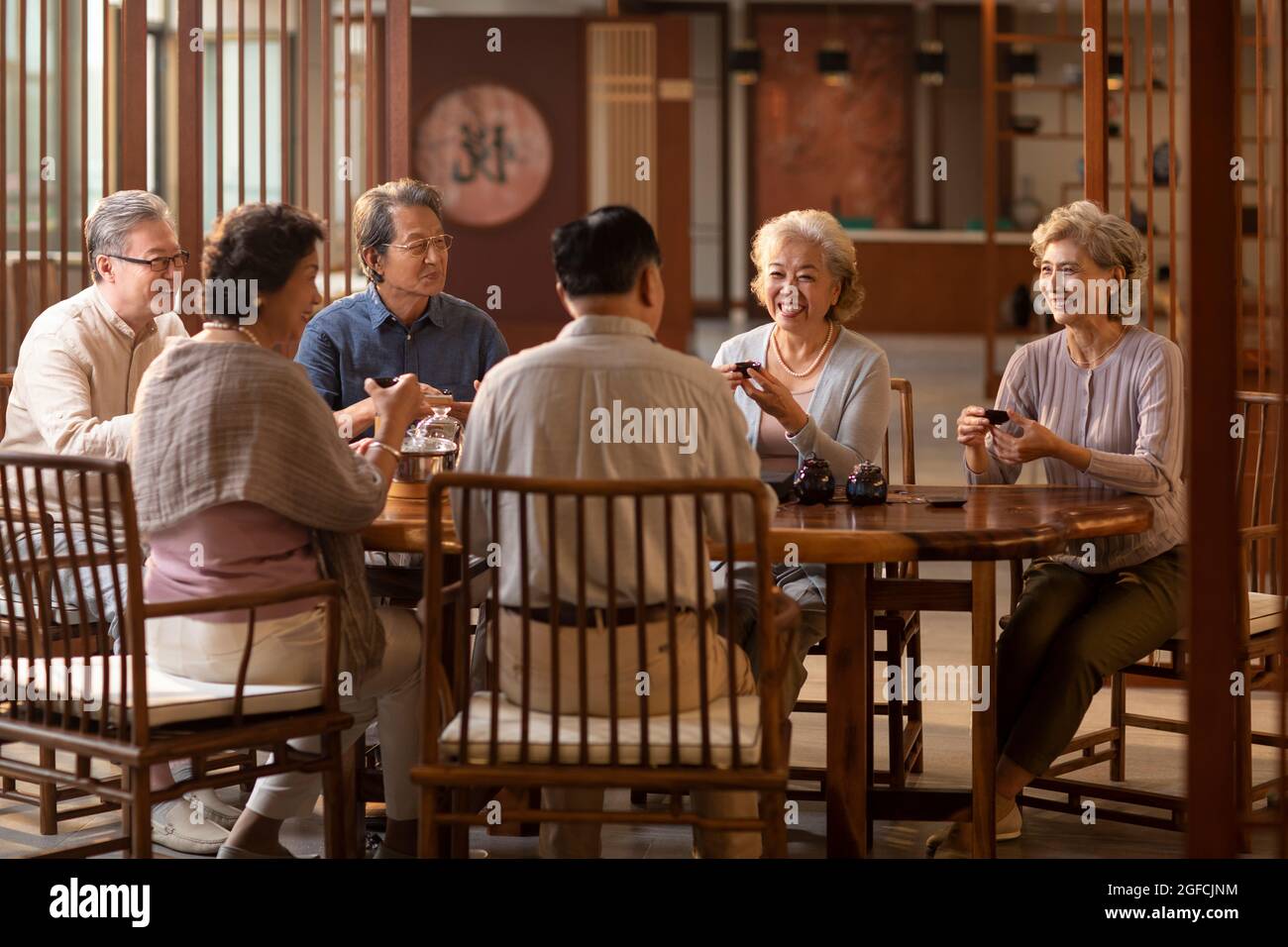 Happy friends drinking tea together Stock Photo - Alamy