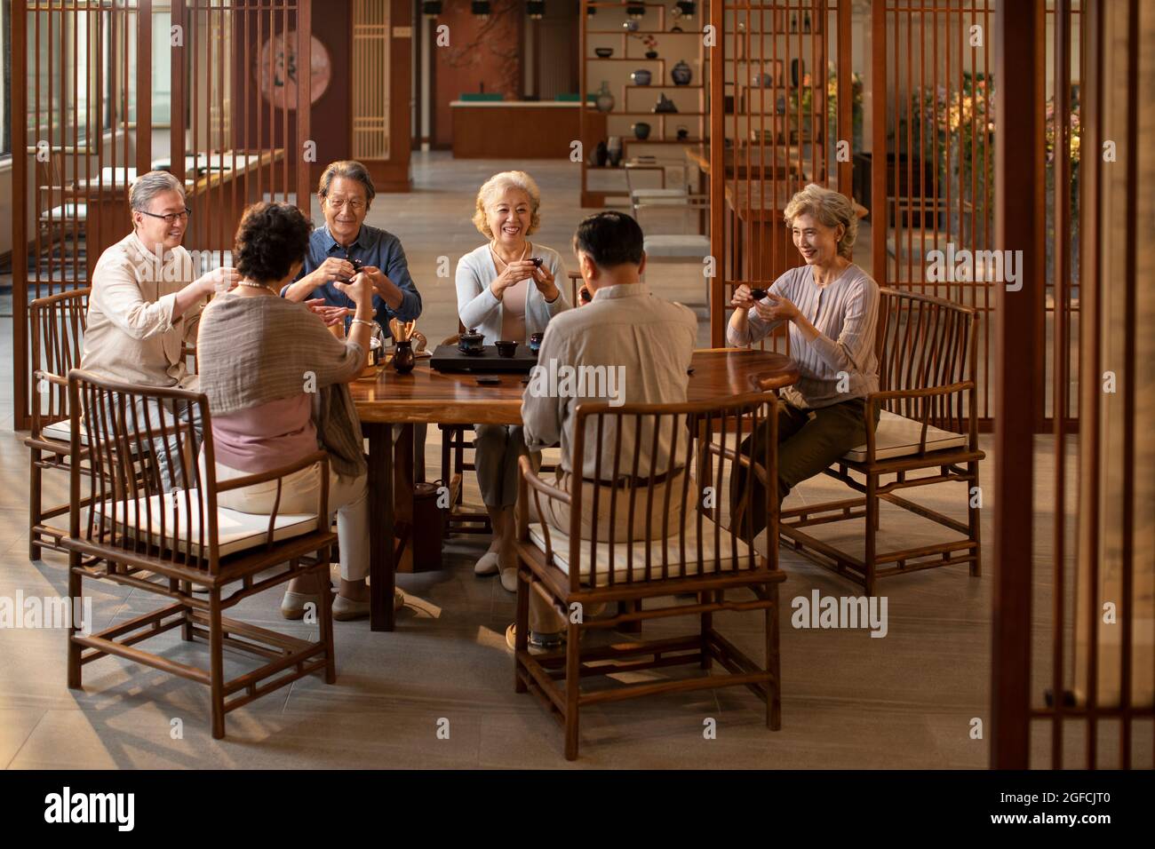 Happy friends drinking tea together Stock Photo - Alamy