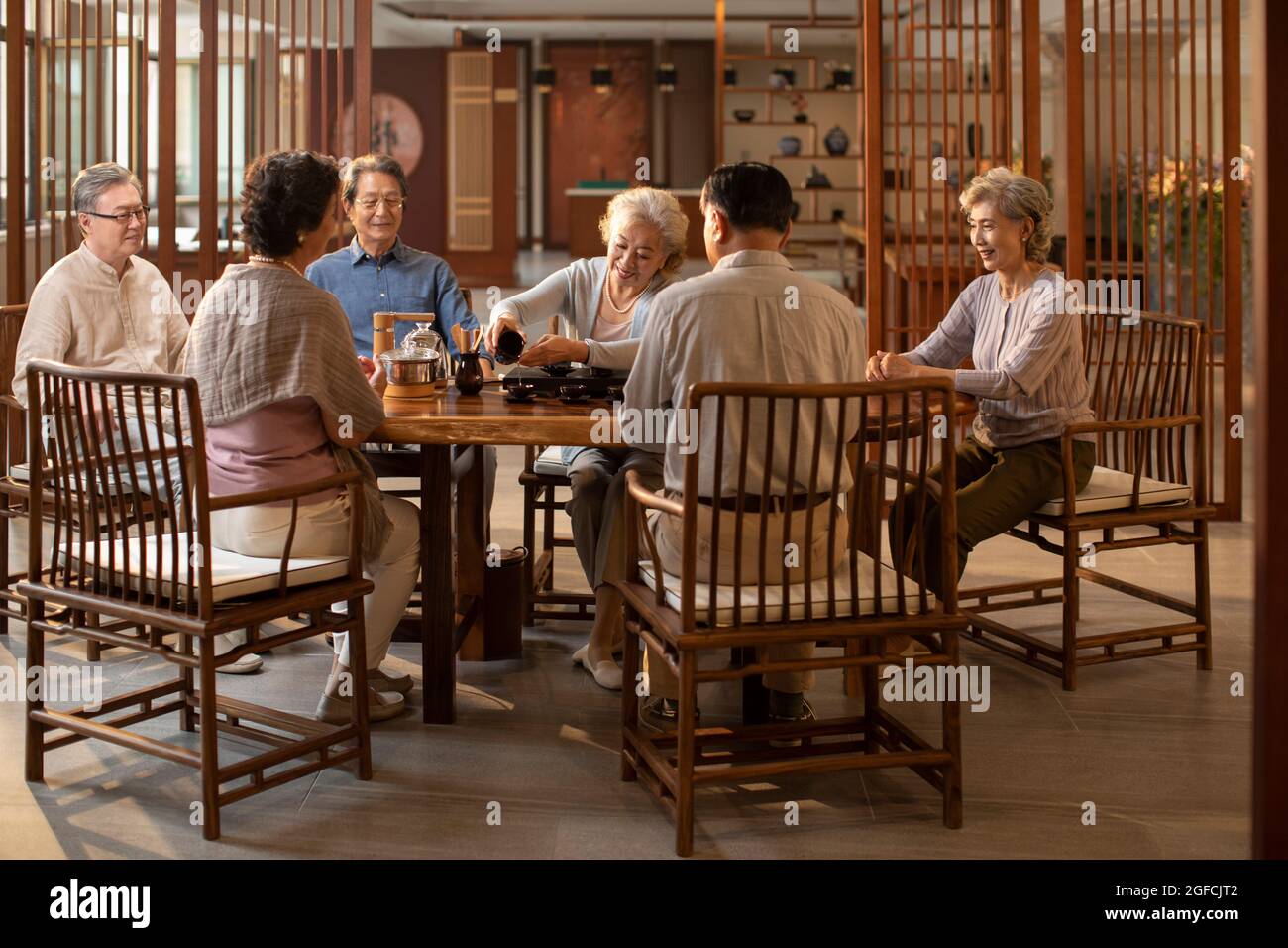 Happy friends drinking tea together Stock Photo - Alamy
