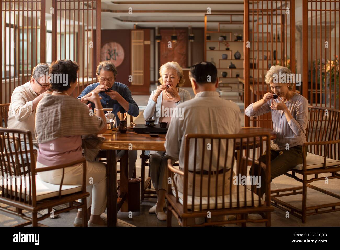 Happy friends drinking tea together Stock Photo - Alamy