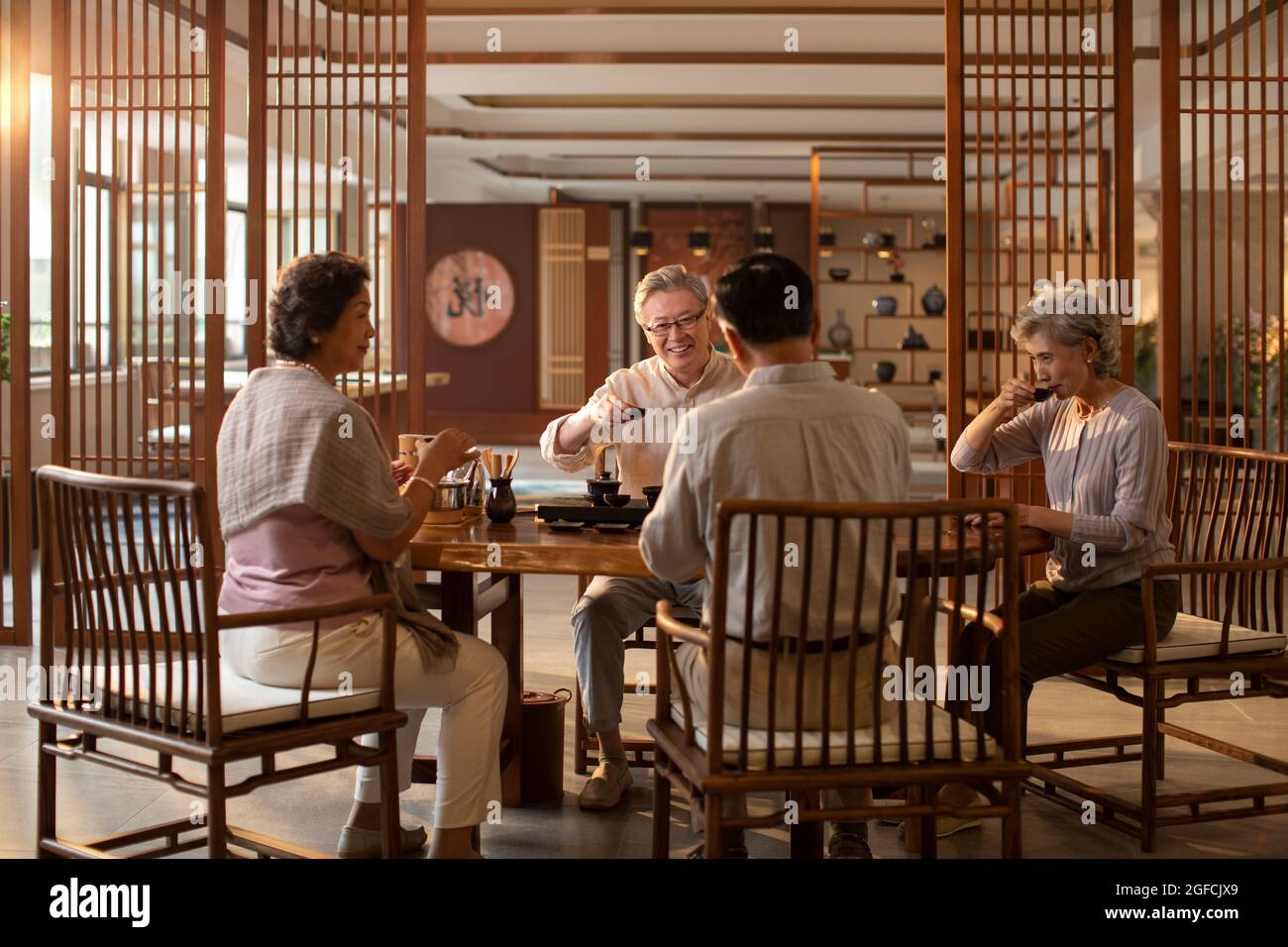 Happy friends drinking tea together Stock Photo - Alamy