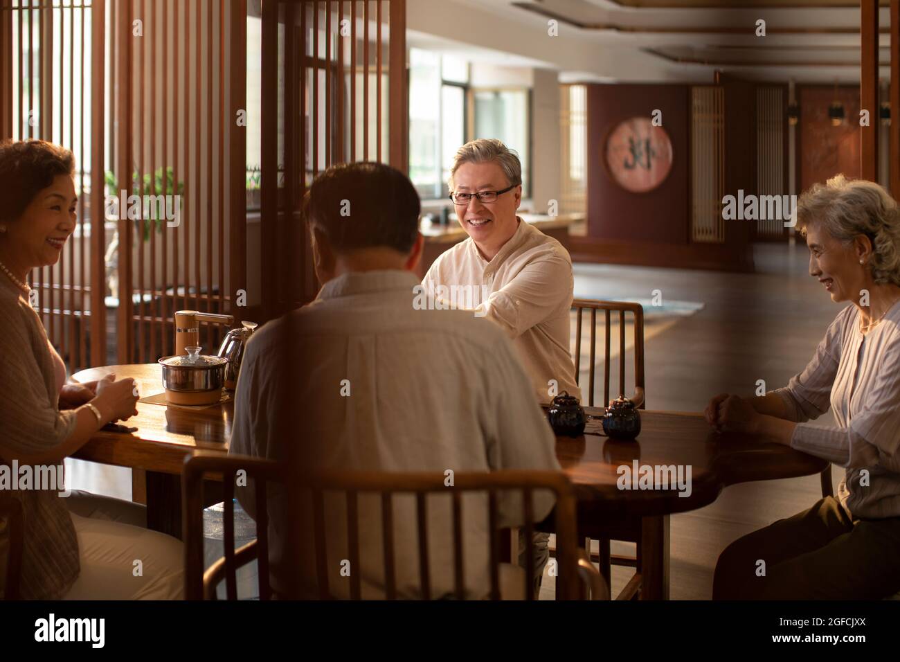 Happy friends drinking tea together Stock Photo - Alamy
