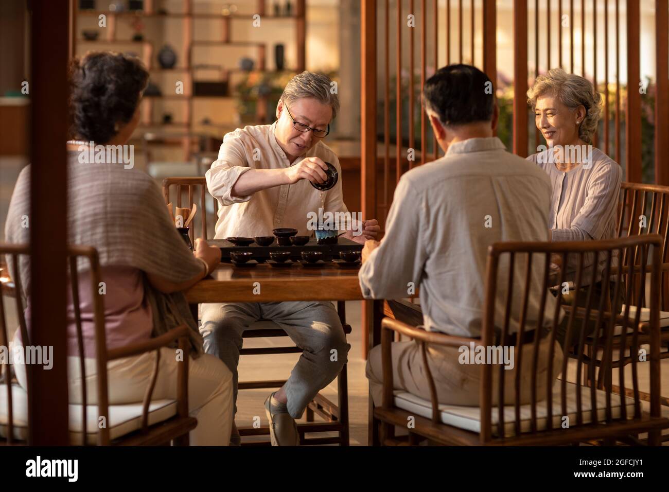Happy friends drinking tea together Stock Photo - Alamy
