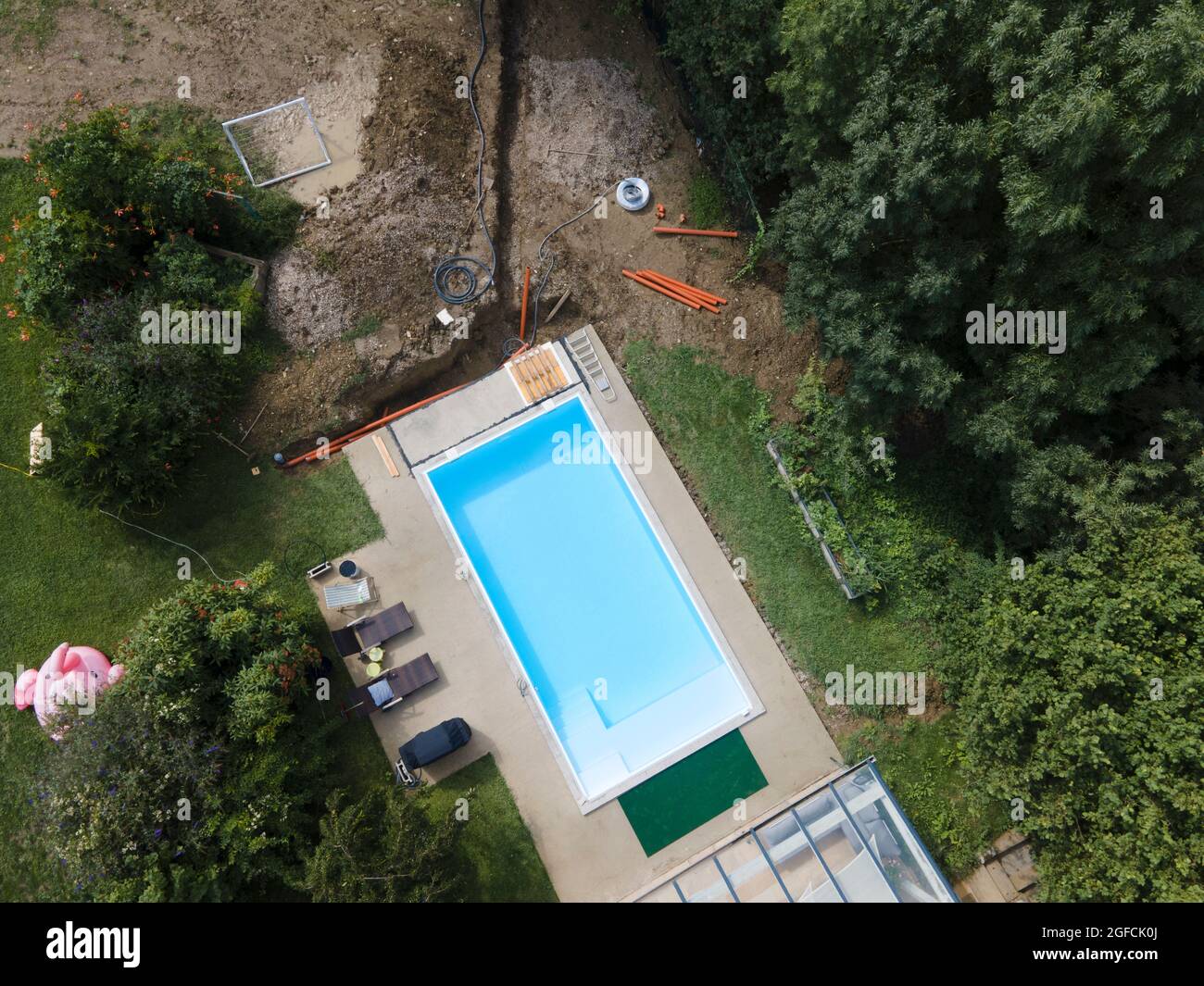 aerial drone flight of pool build construction site with pool filled ...