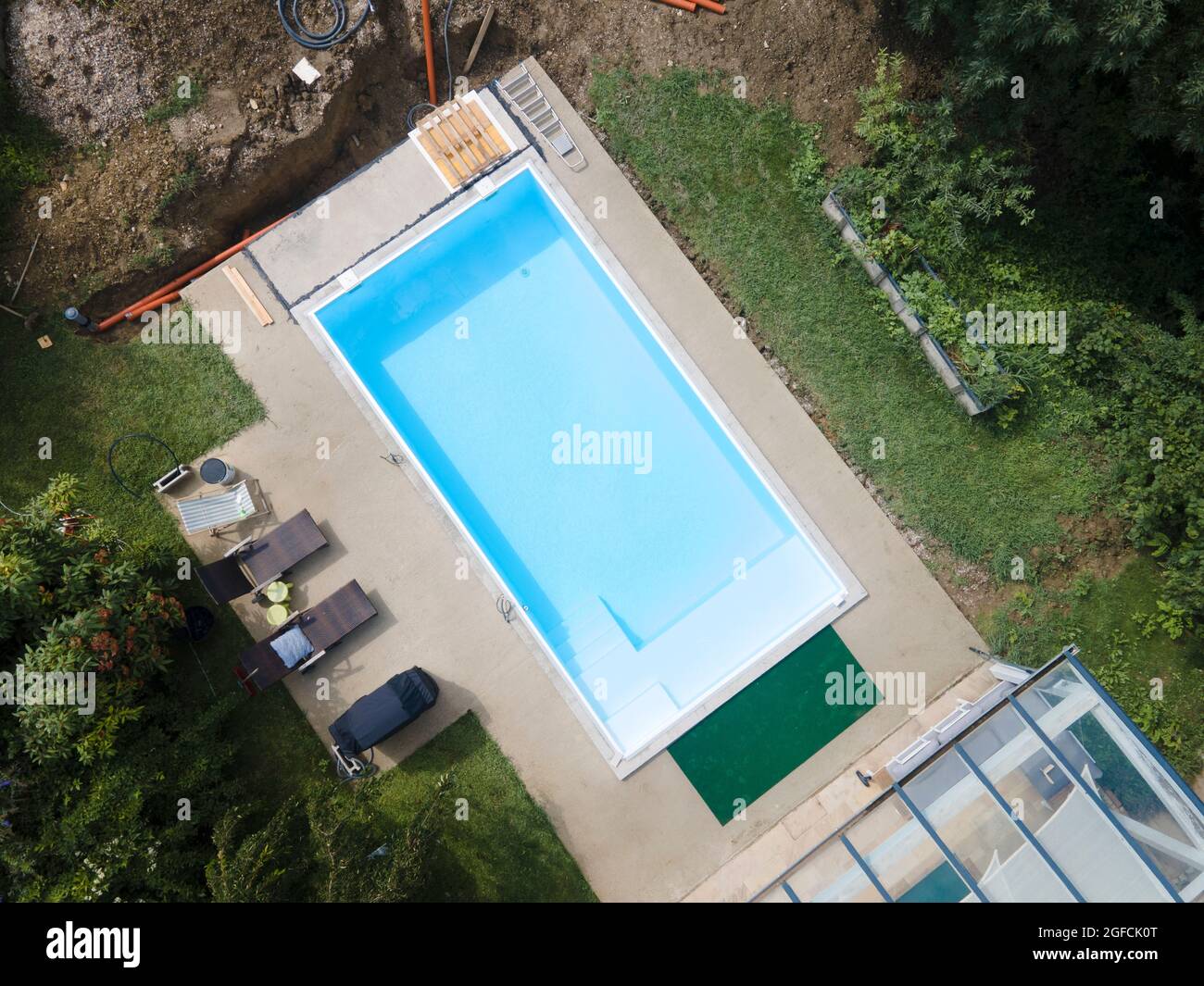 aerial drone flight of pool build construction site with pool filled ...