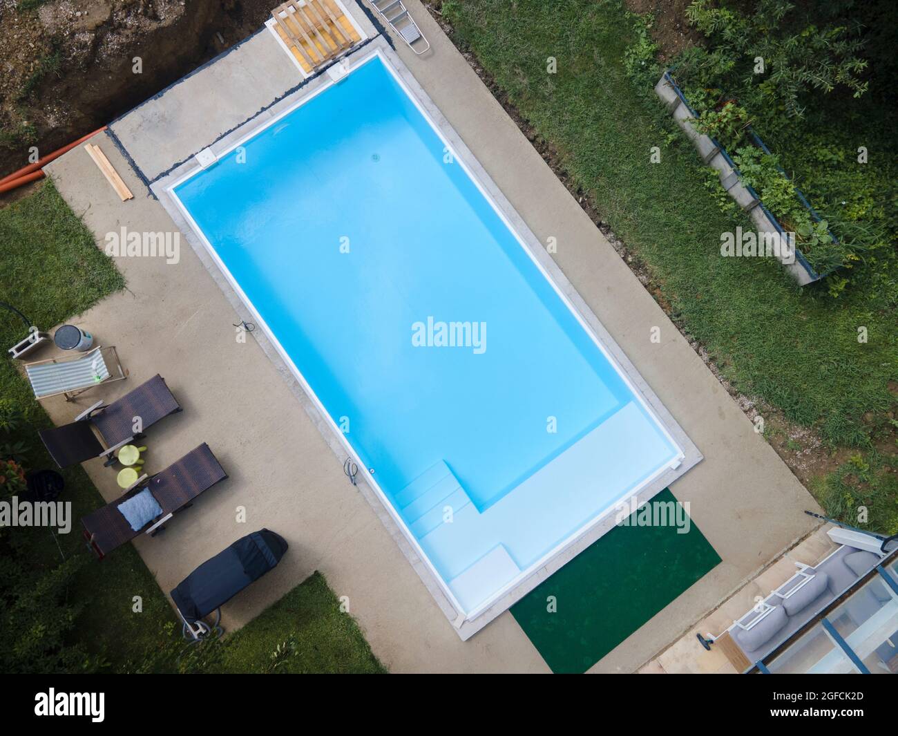 aerial drone flight of pool build construction site with pool filled ...