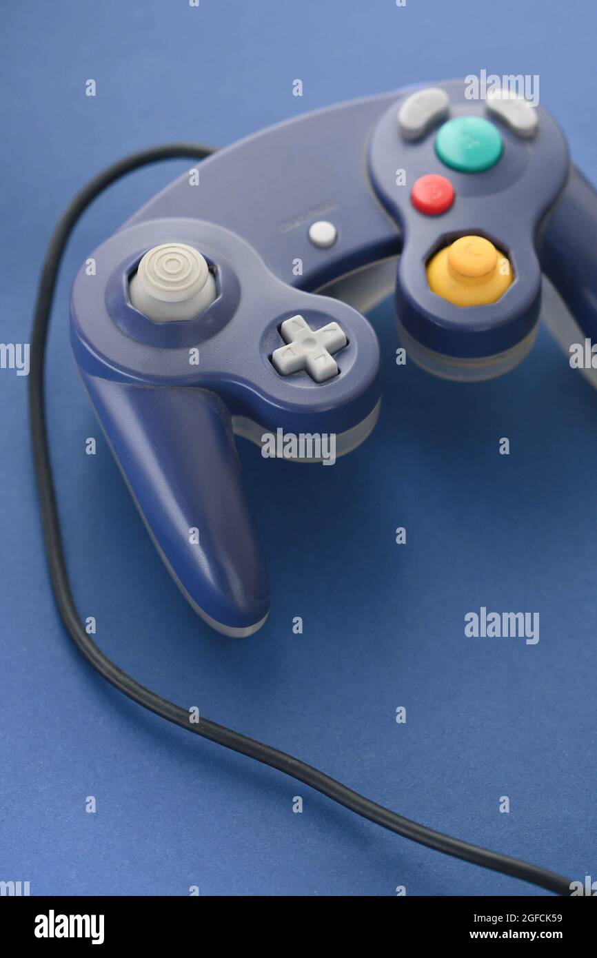 Photo of a gaming controller on blue background Stock Photo - Alamy