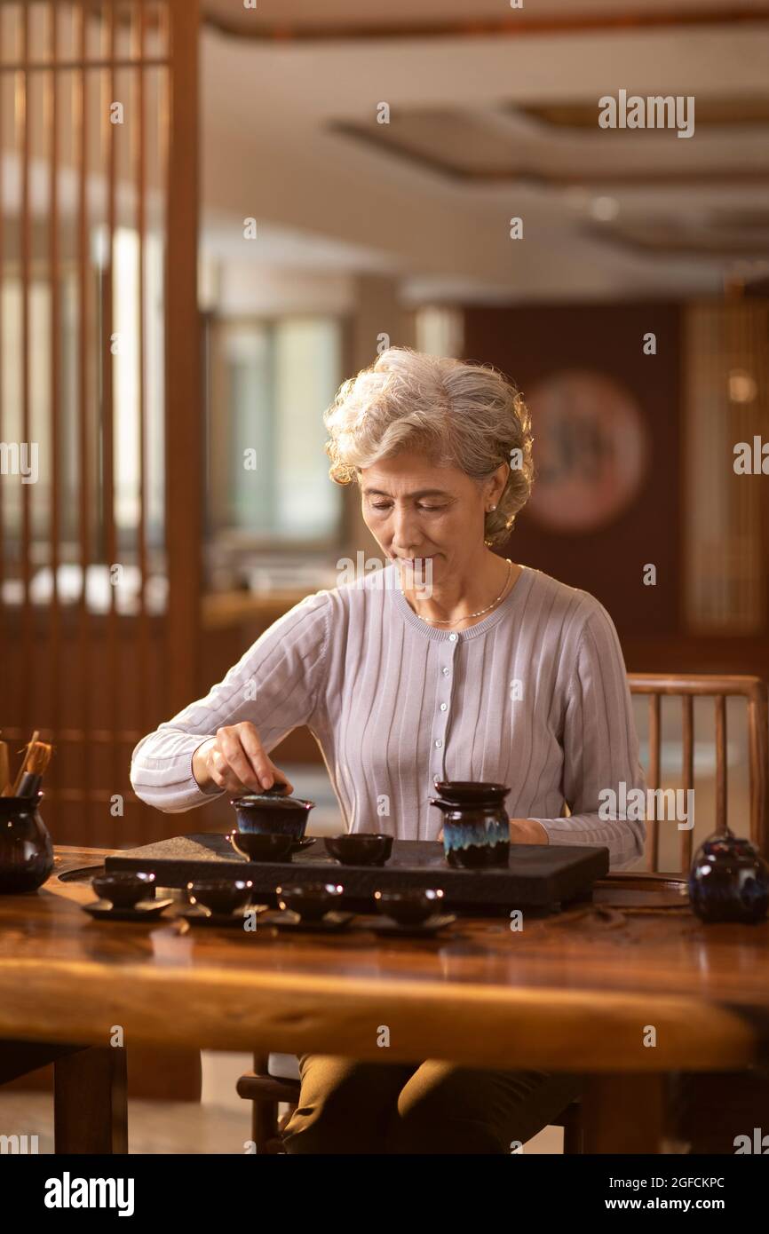 Senior woman performing tea ceremony Stock Photo - Alamy