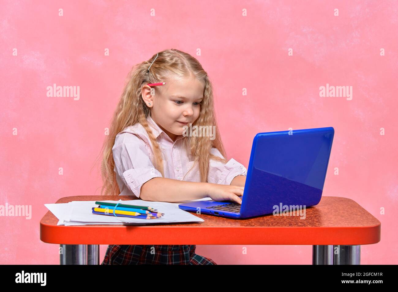 little girl is typing at the laptop. online learning Stock Photo - Alamy