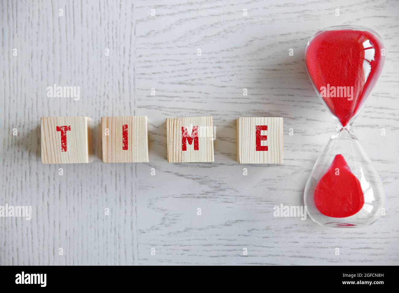 Word TIME with hourglass on wooden background Stock Photo - Alamy
