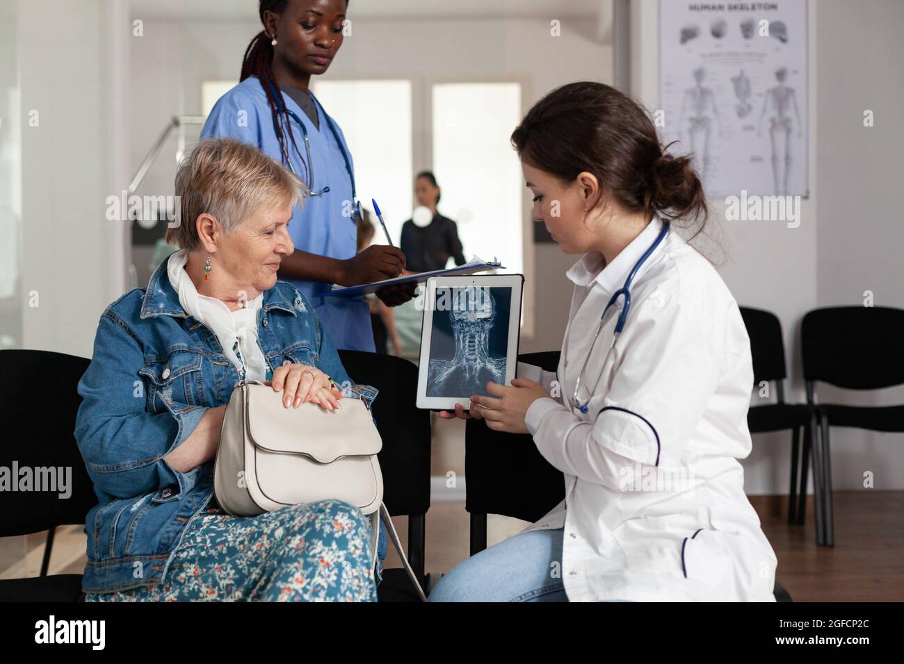 Physician doctor explaining medical radiography to elderly senior woman ...