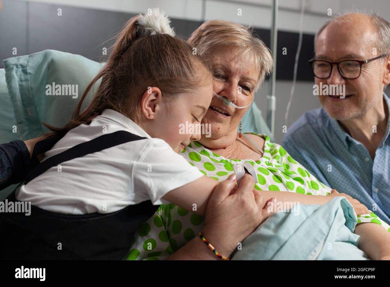 Close-up of granddaughter showing support to grandmother, hugging her ...