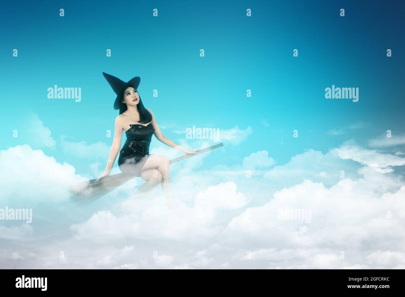 Asian witch woman with hat flying on a magic broomstick with ...