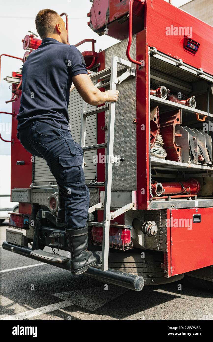 Fireman working in fire truck with special equipment Stock Photo - Alamy
