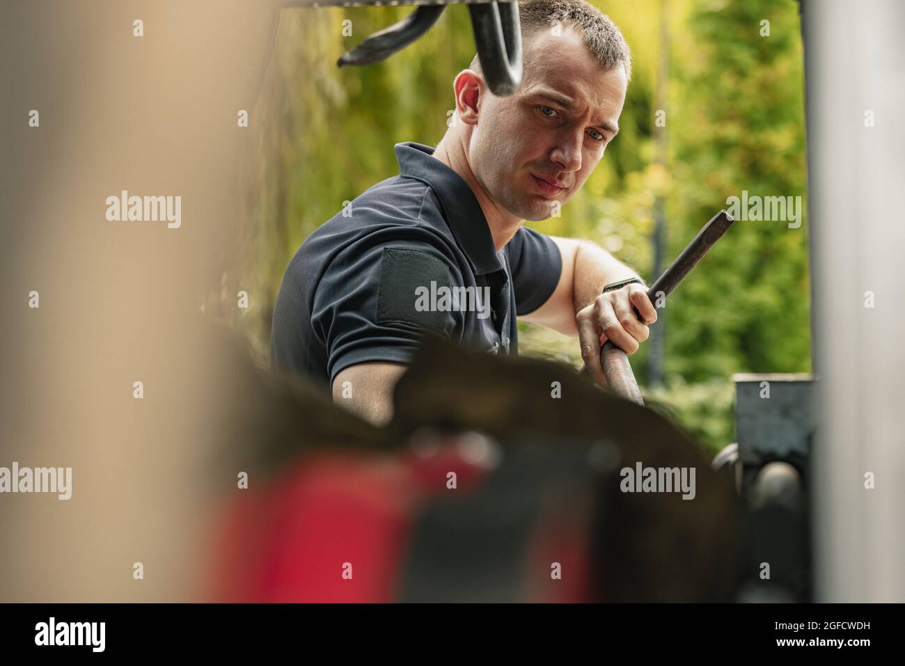 Fireman working in fire truck with special equipment Stock Photo - Alamy