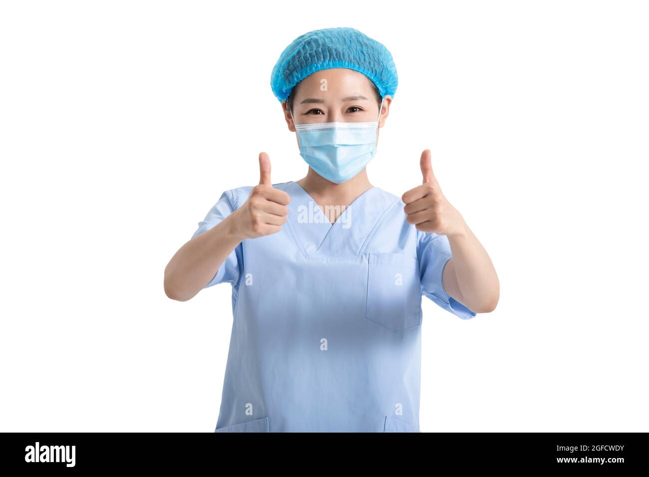 Young doctor with surgical mask giving thumbs-up Stock Photo - Alamy