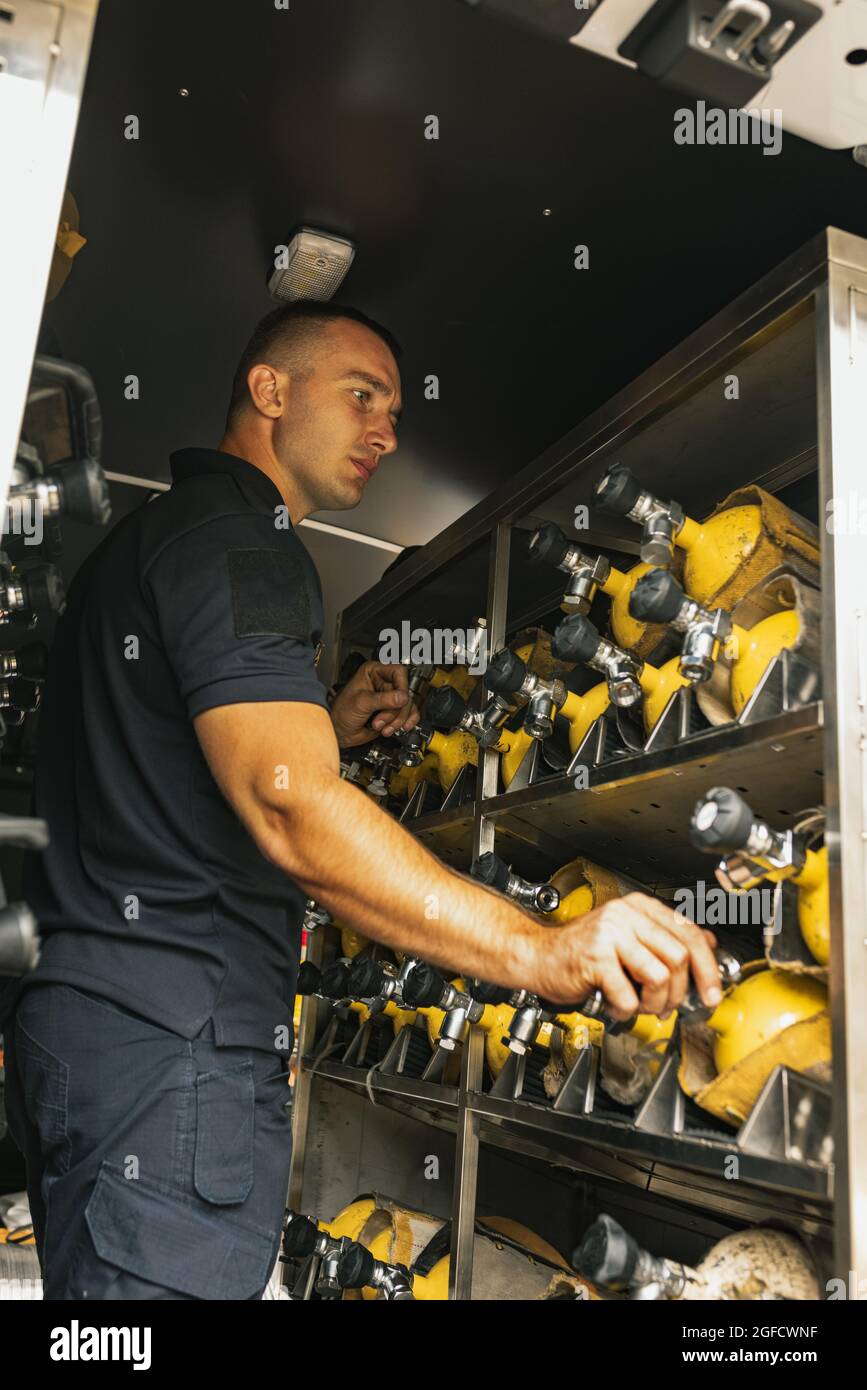 Male firefighter holding fire extinguisher in truck Stock Photo - Alamy