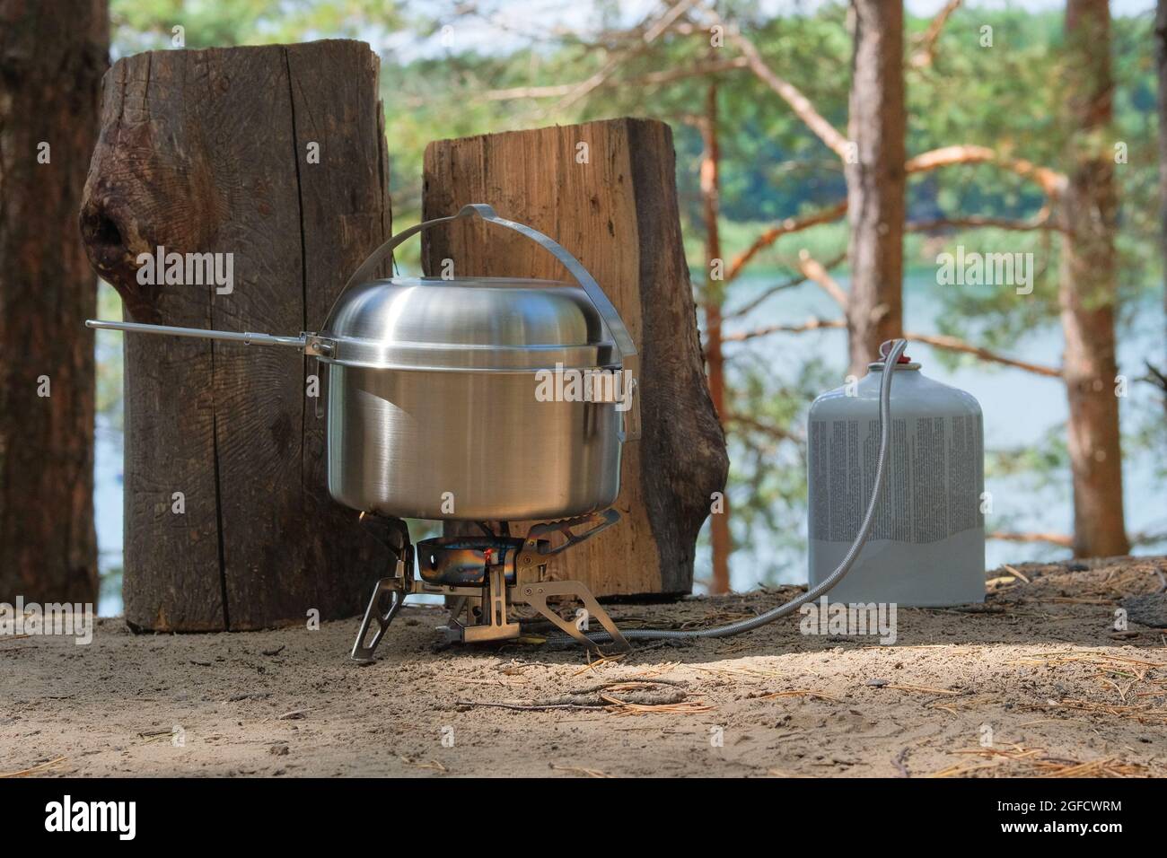 Traveler foods for outdoor activities. Food in pot in the green forest ...