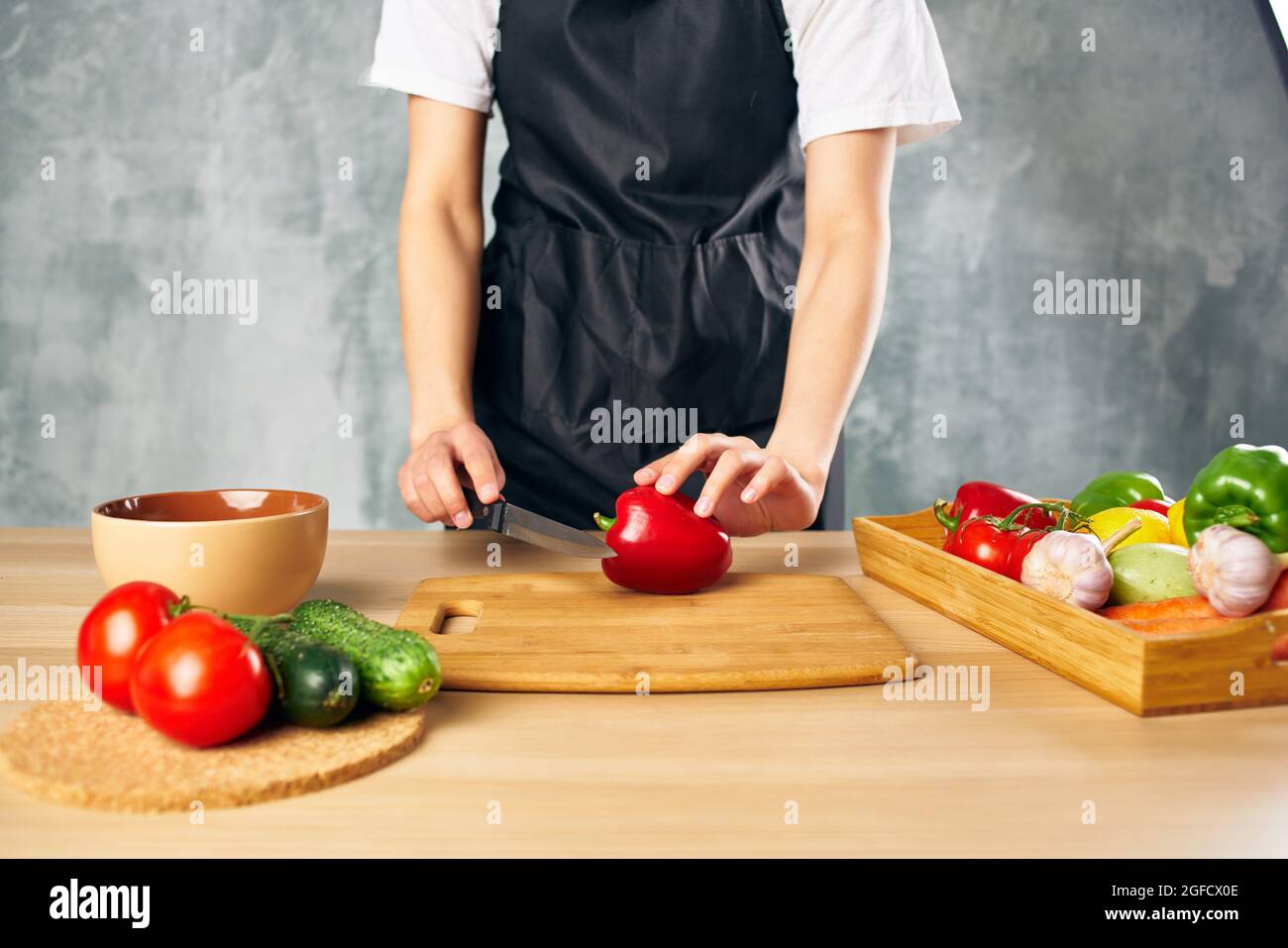 Woman in black apron Cooking healthy eating Stock Photo - Alamy