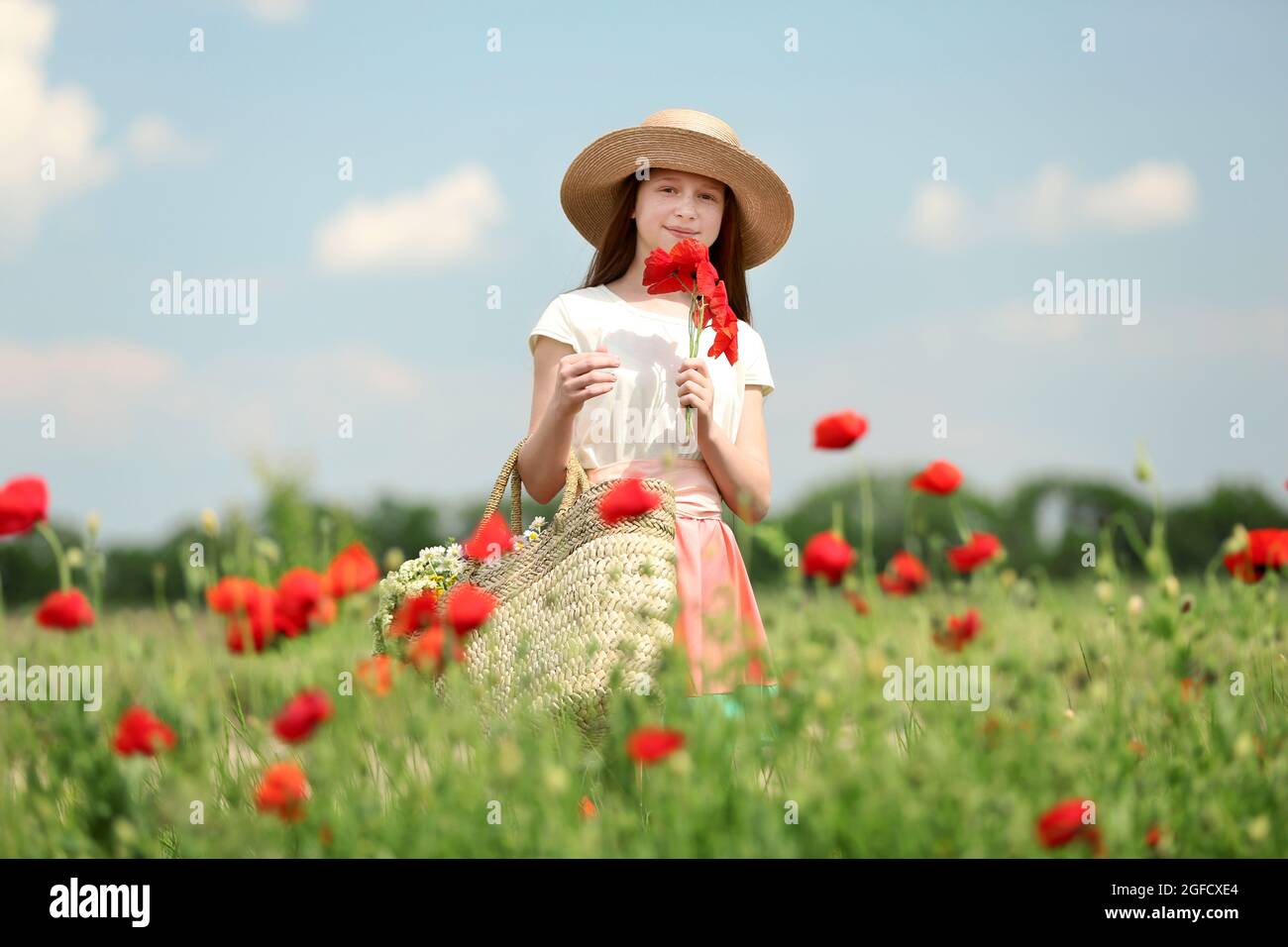 Beautiful girl in poppy field Stock Photo - Alamy