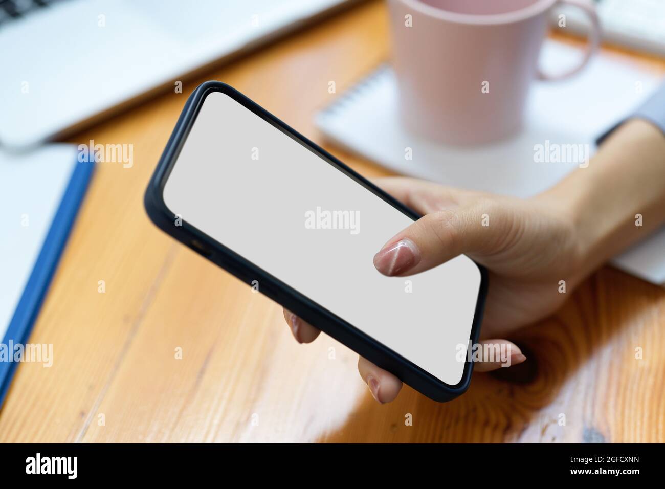 Closeup, Smartphone blank screen mockup, female employee using phone ...
