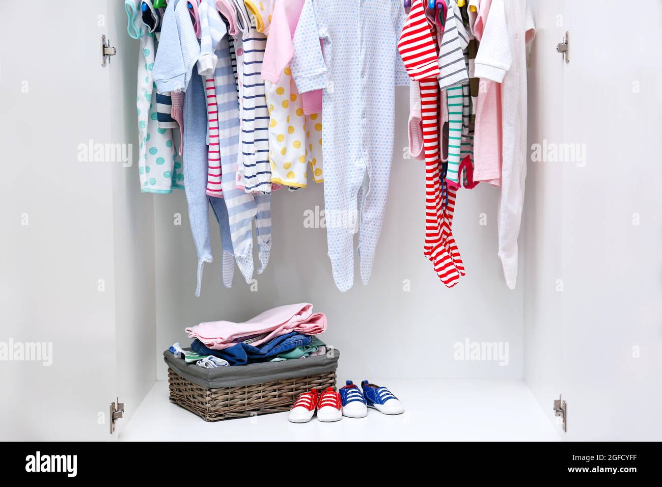 Clothes for kids in wardrobe Stock Photo - Alamy