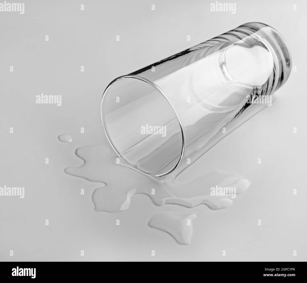 Glass with drops on light background Stock Photo - Alamy
