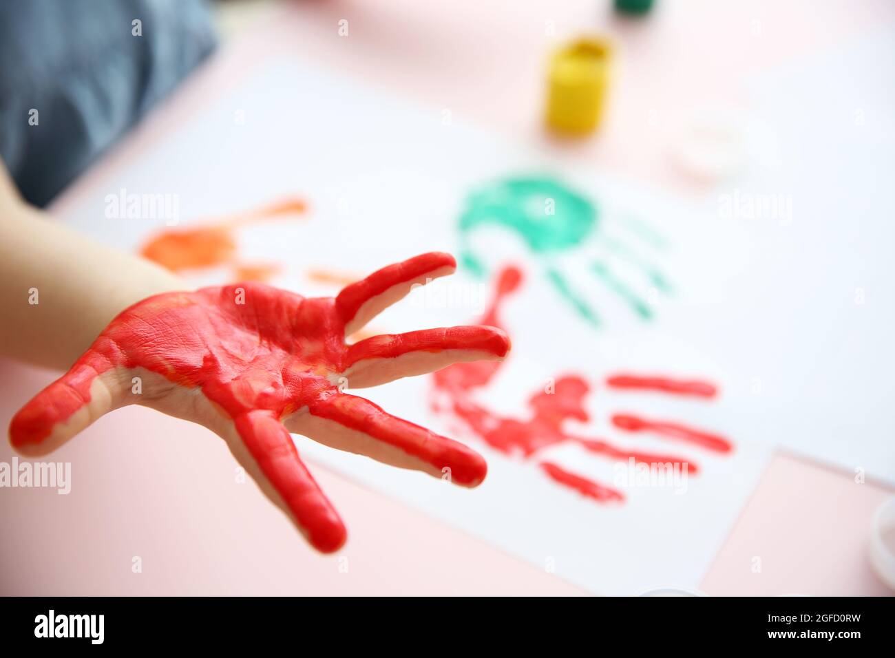 Child making hand prints on paper Stock Photo - Alamy