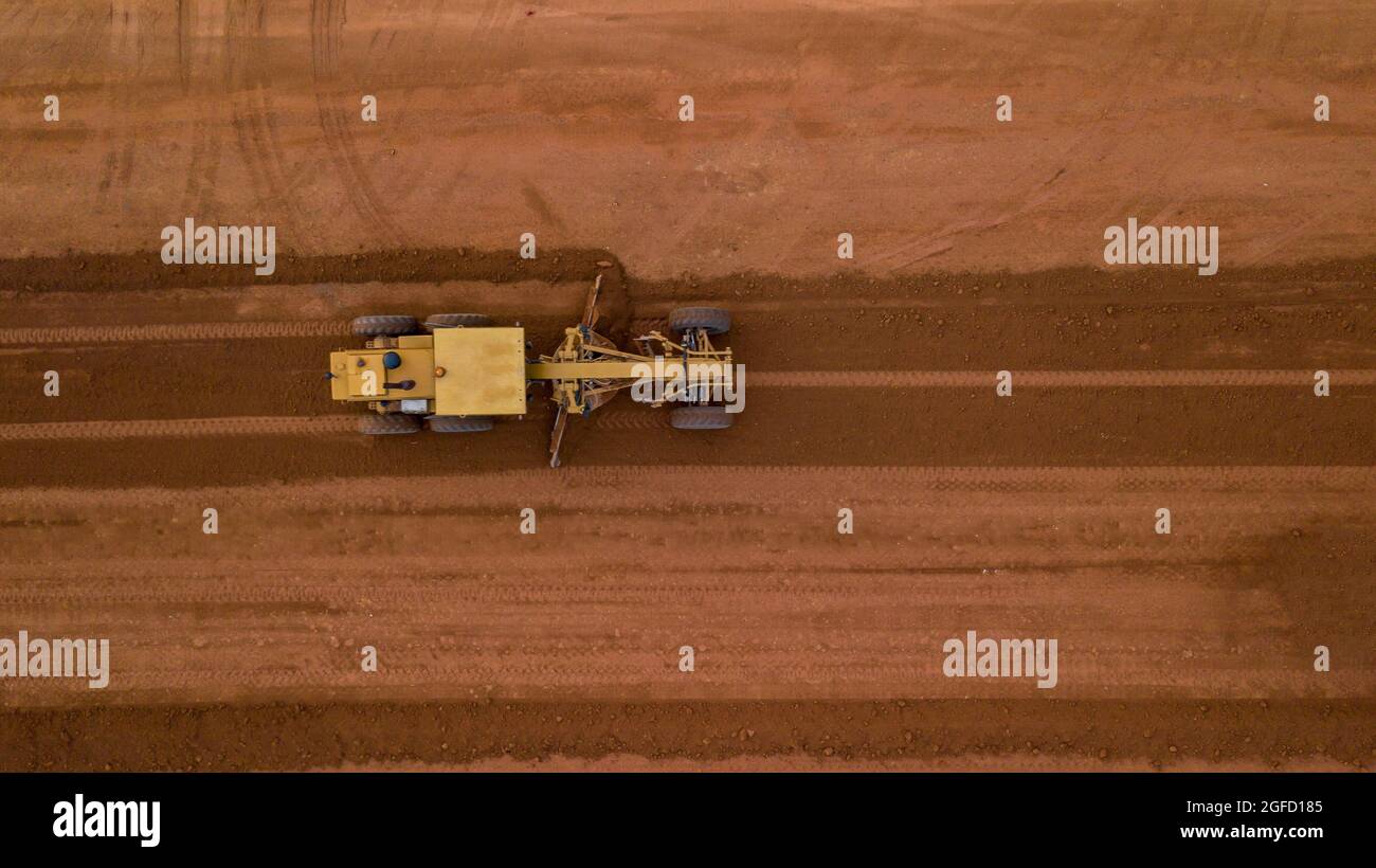 Aerial view yellow excavator building a highway, Road grader heavy ...