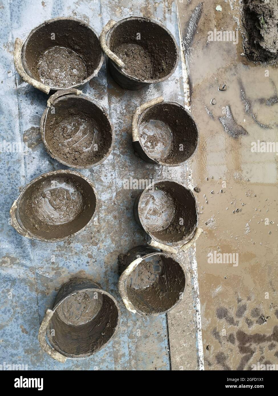 Top view of cement buckets at the construction site Stock Photo - Alamy
