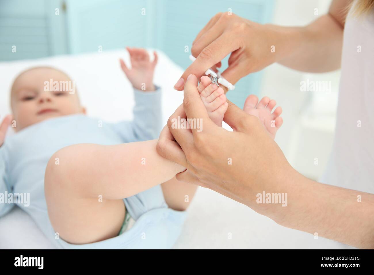 Mother cutting kids nails Stock Photo - Alamy