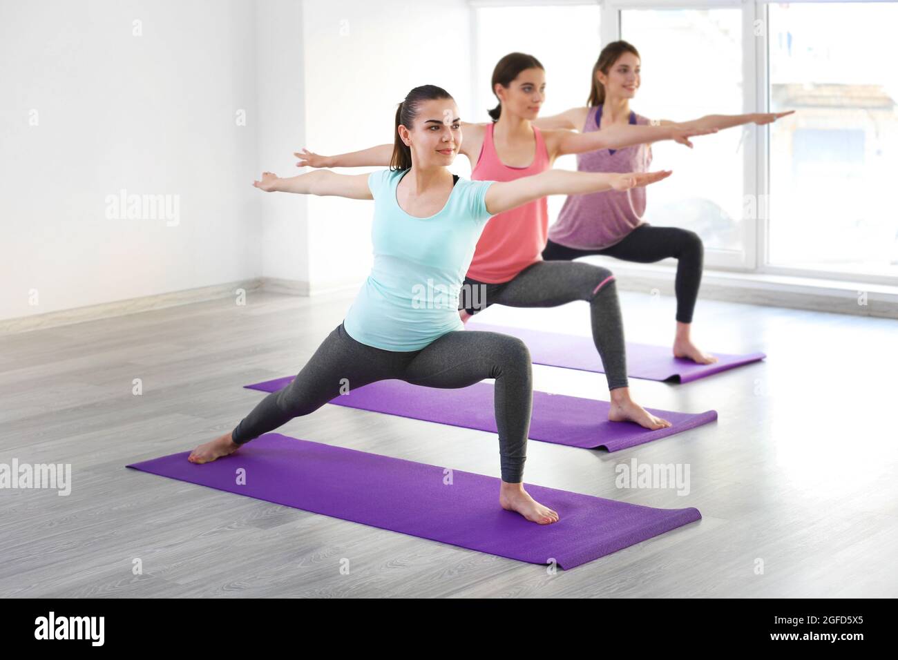 Young women doing exercise in gym Stock Photo - Alamy