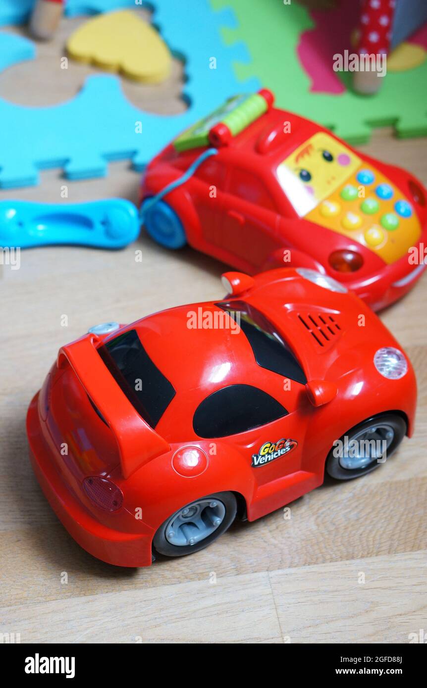 POZNAN, POLAND - May 15, 2016: A vertical shot of red plastic car toys ...