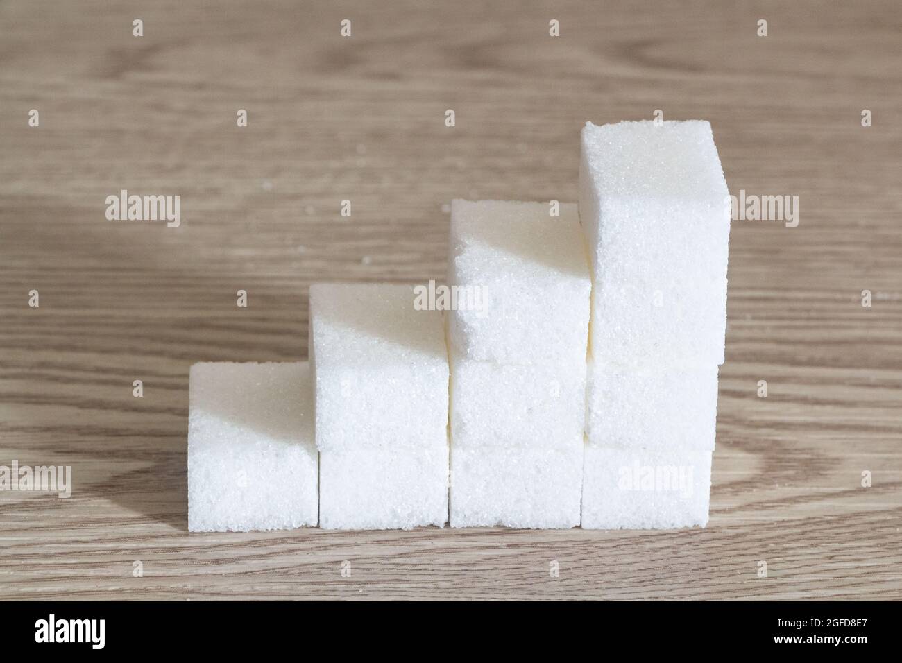 Increasing heaps of sugar cubes for overconsumption of sugar Stock ...