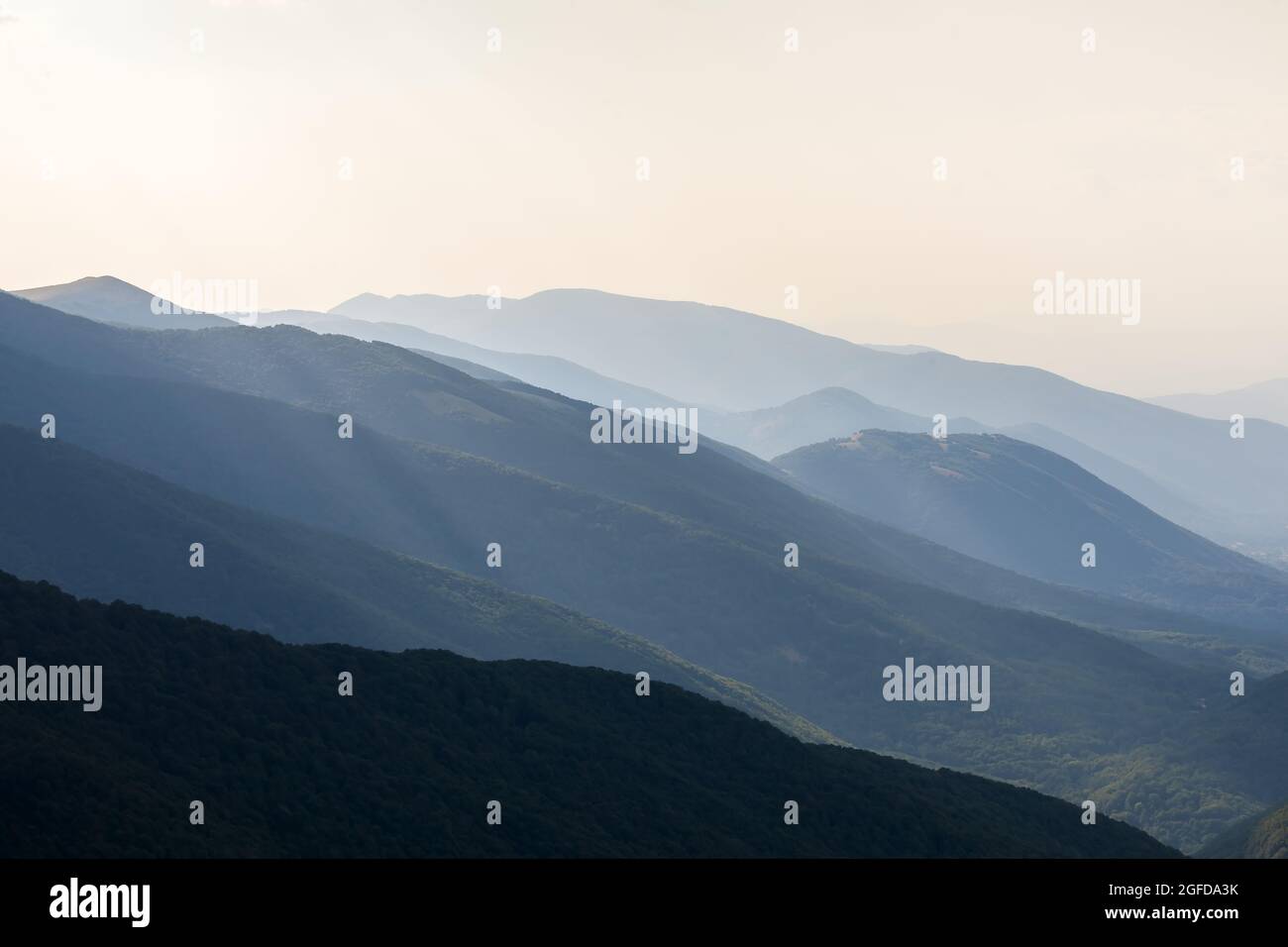 Mountain peaks illuminated by sunlight create a beautiful landscape for ...