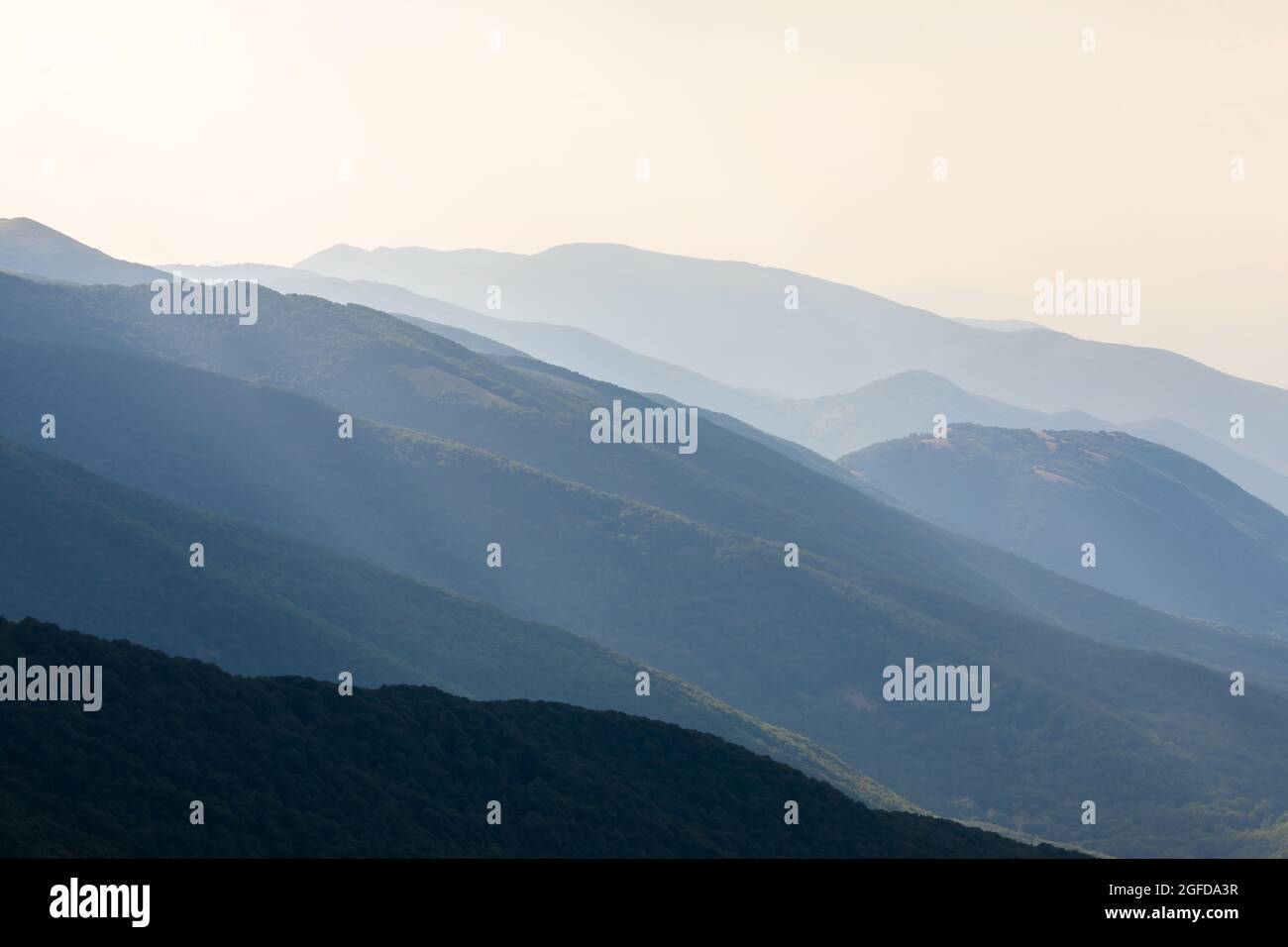 Mountain peaks illuminated by sunlight create a beautiful landscape for ...