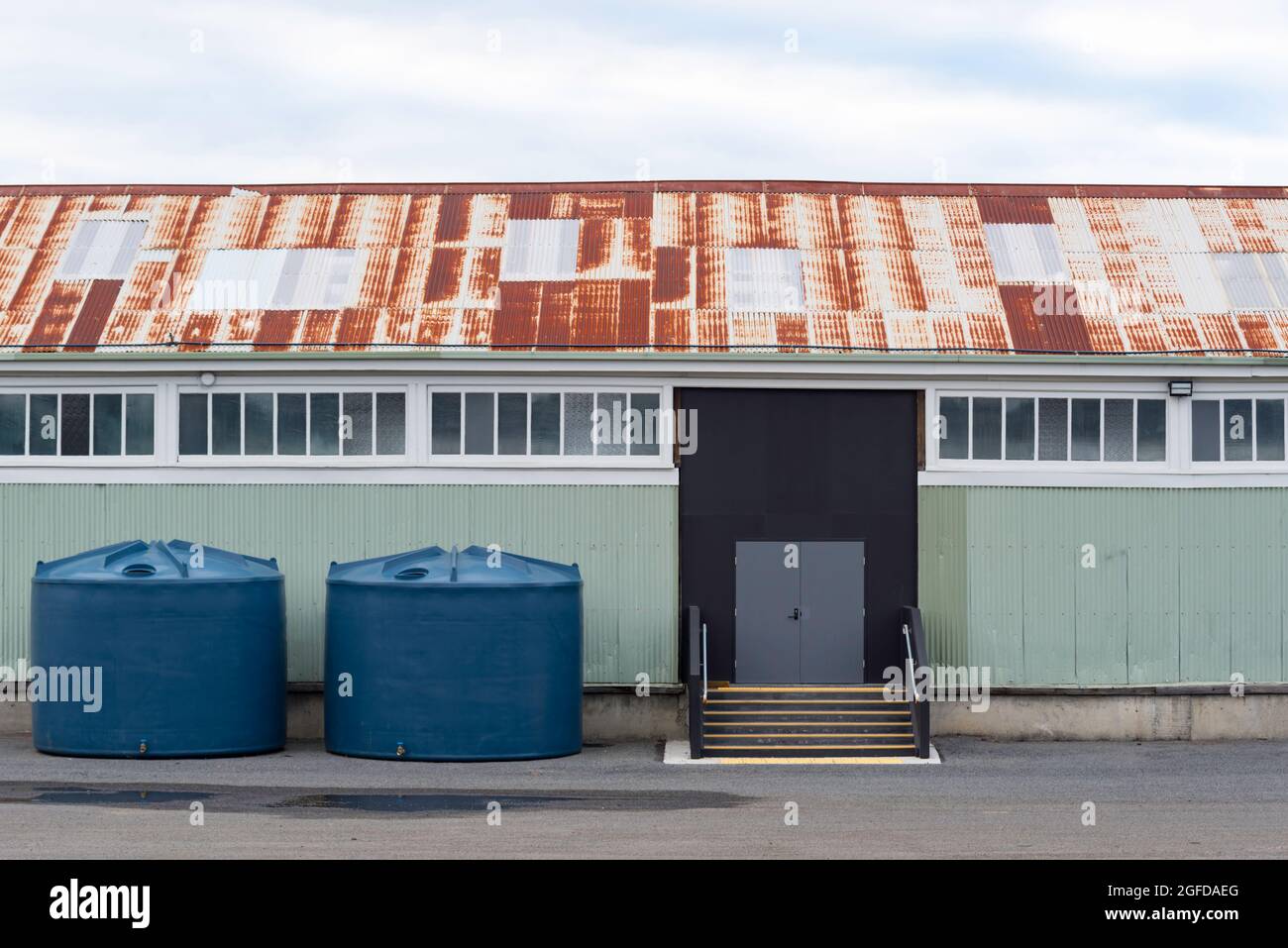 A long single-level dockside warehouse and access door from side on in ...