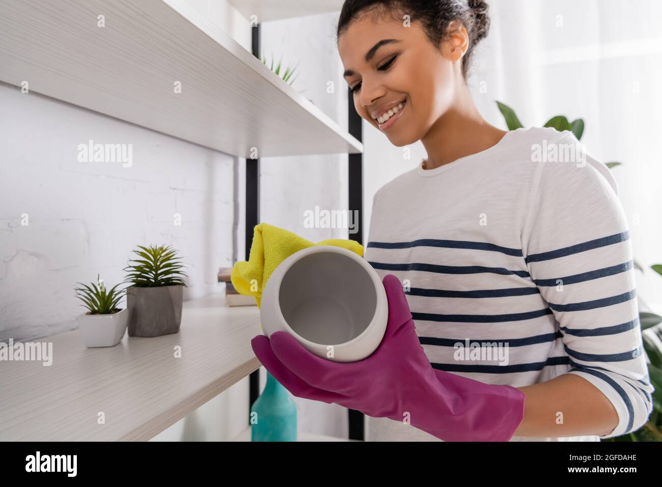 Smiling african american woman cleaning hi-res stock photography and ...