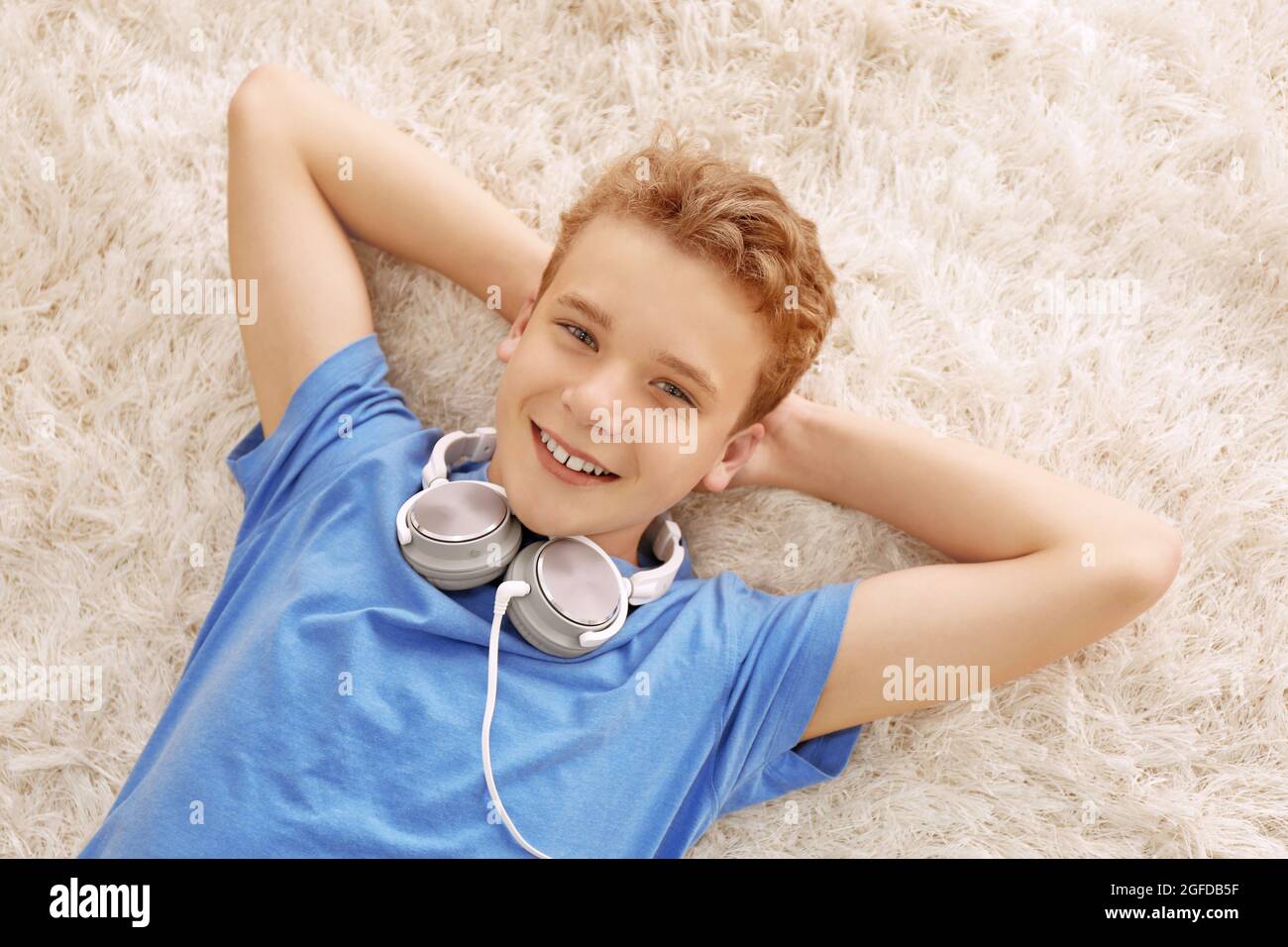 Boy laying on carpet Stock Photo - Alamy