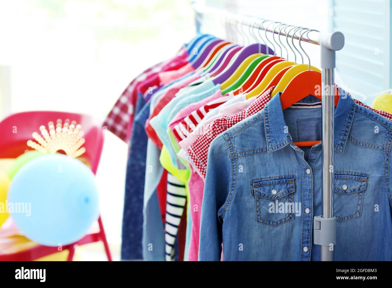 Children clothes hanging on hangers in the shop Stock Photo - Alamy