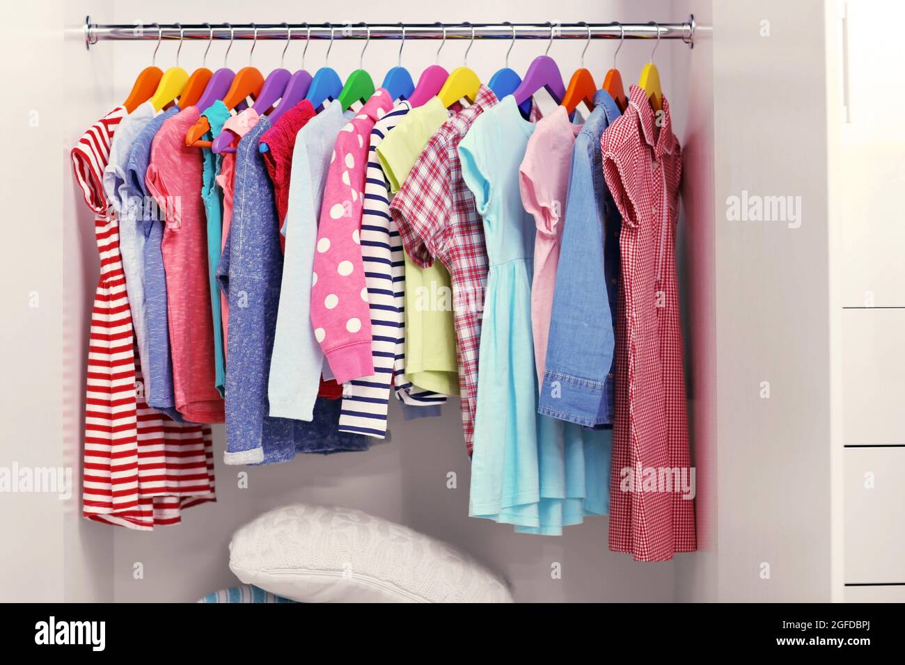Children clothes hanging on hangers in the wardrobe Stock Photo - Alamy