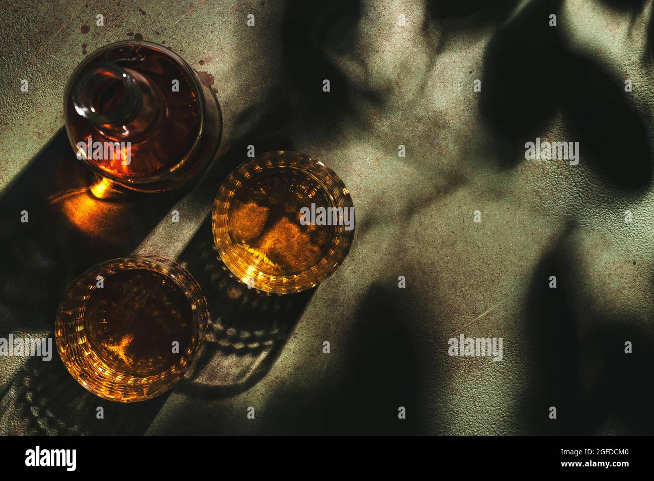 American bourbon whiskey in glasses and bottle, rusty green background ...