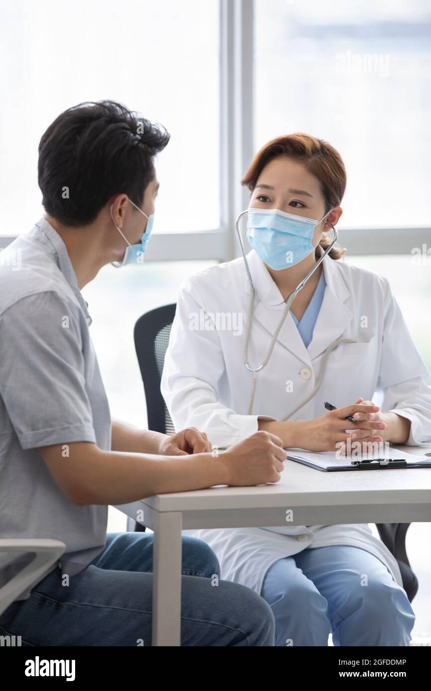 Doctor talking with patient Stock Photo - Alamy