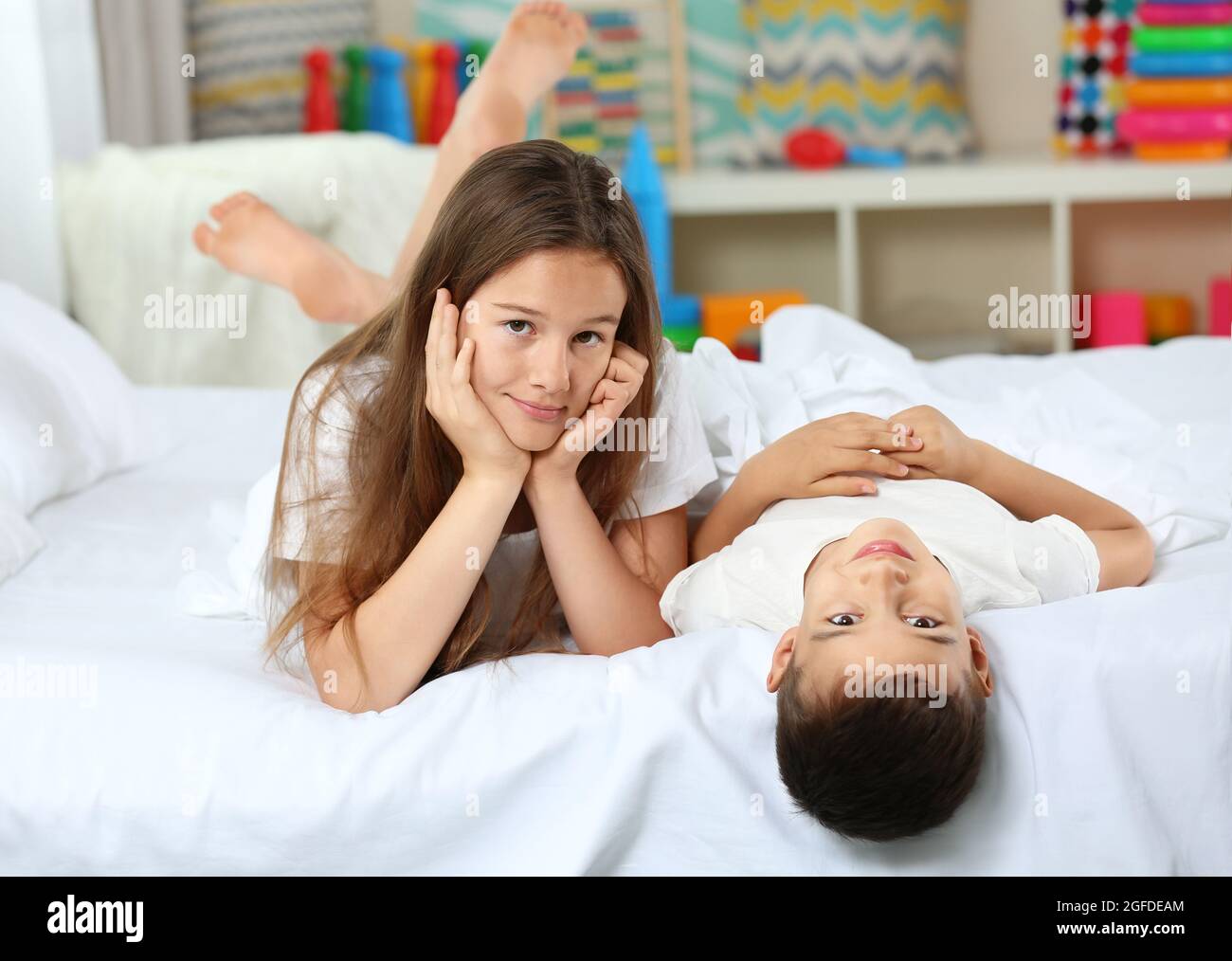 Brother and sister on bed Stock Photo - Alamy