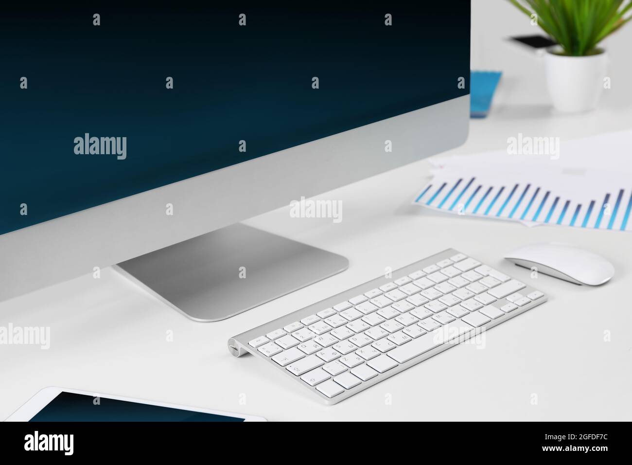 Computer on white table Stock Photo - Alamy