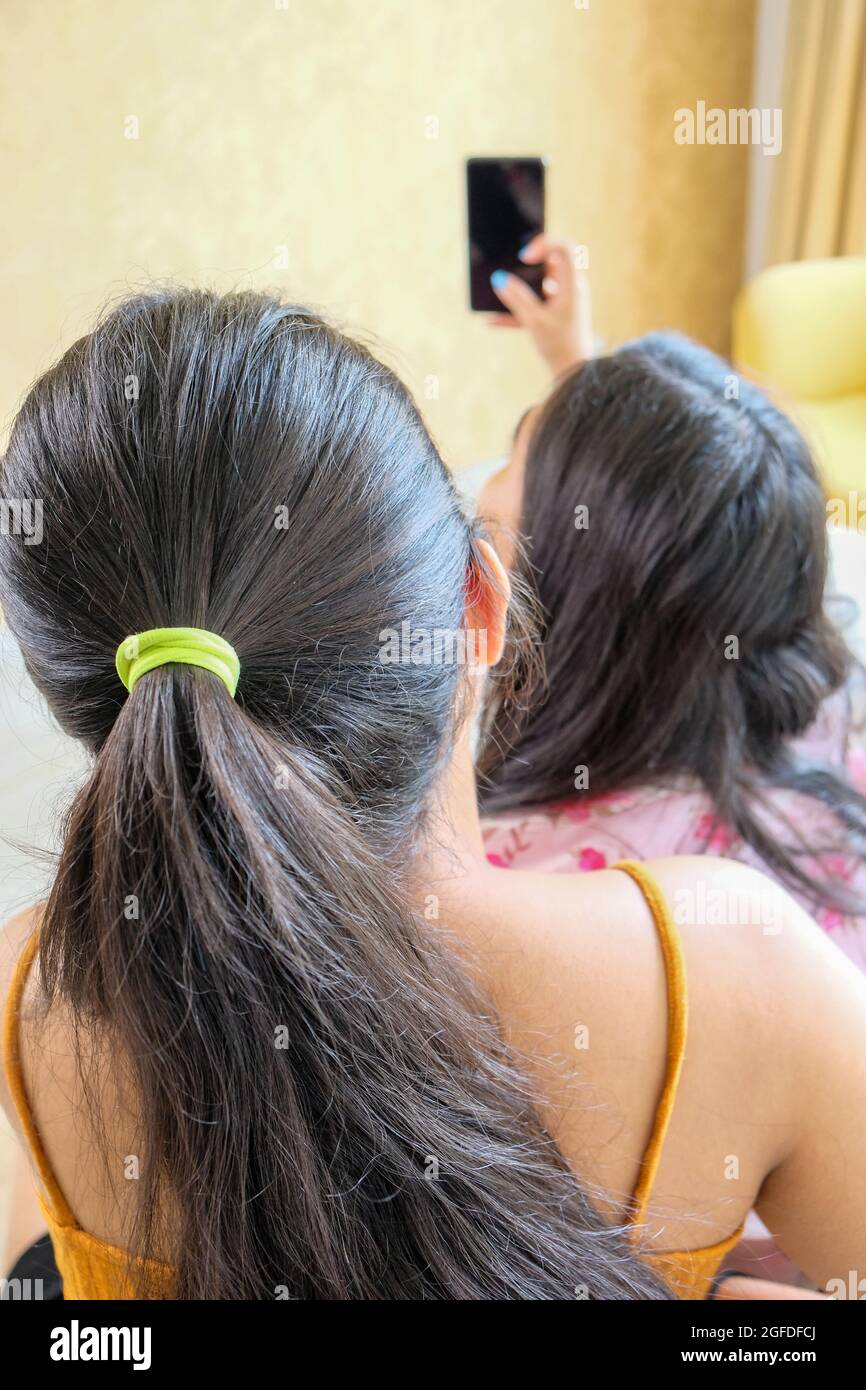Vertical closeup of two girls taking a selfie Stock Photo - Alamy