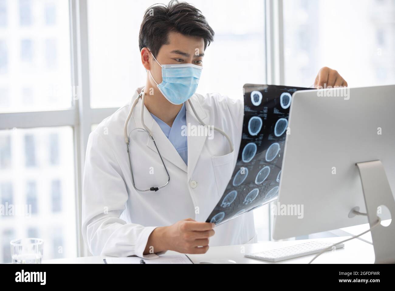 Young doctor checking X-ray image Stock Photo - Alamy