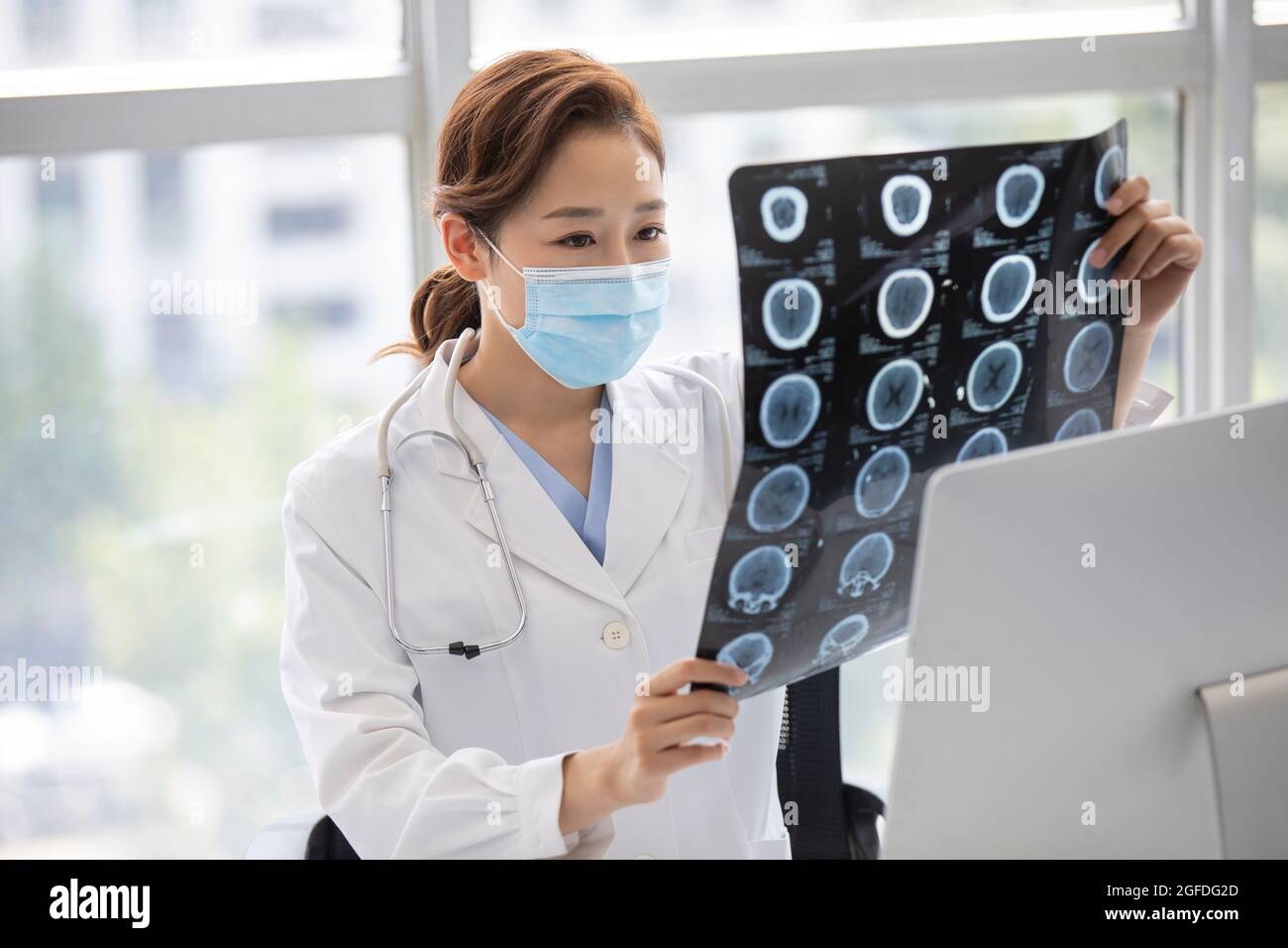 Young doctor checking X-ray image Stock Photo - Alamy