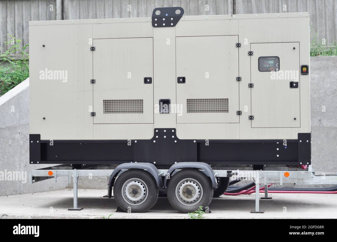 A close-up of a quiet towable, standalone emergency gaseous generator ...