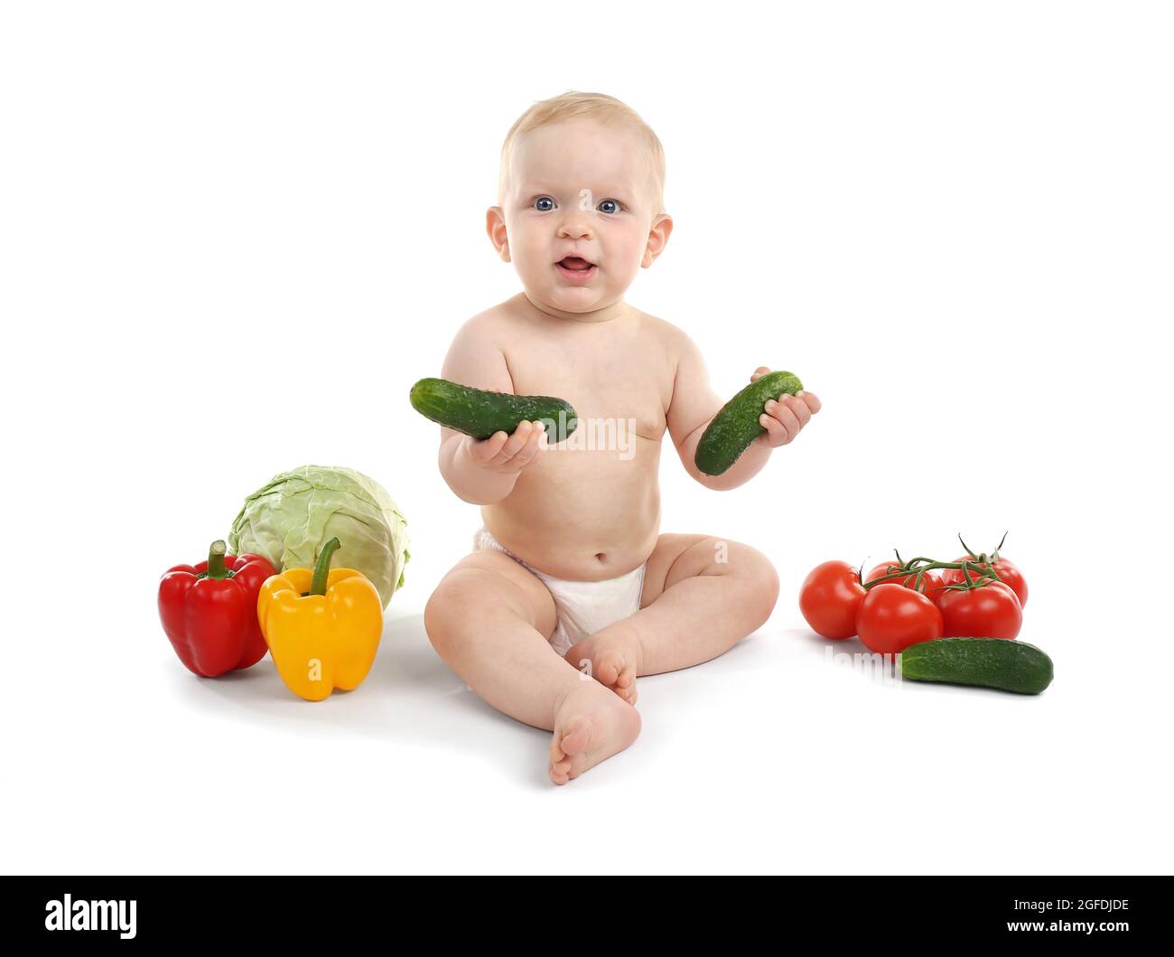 Cute baby and fresh vegetables on white background Stock Photo - Alamy